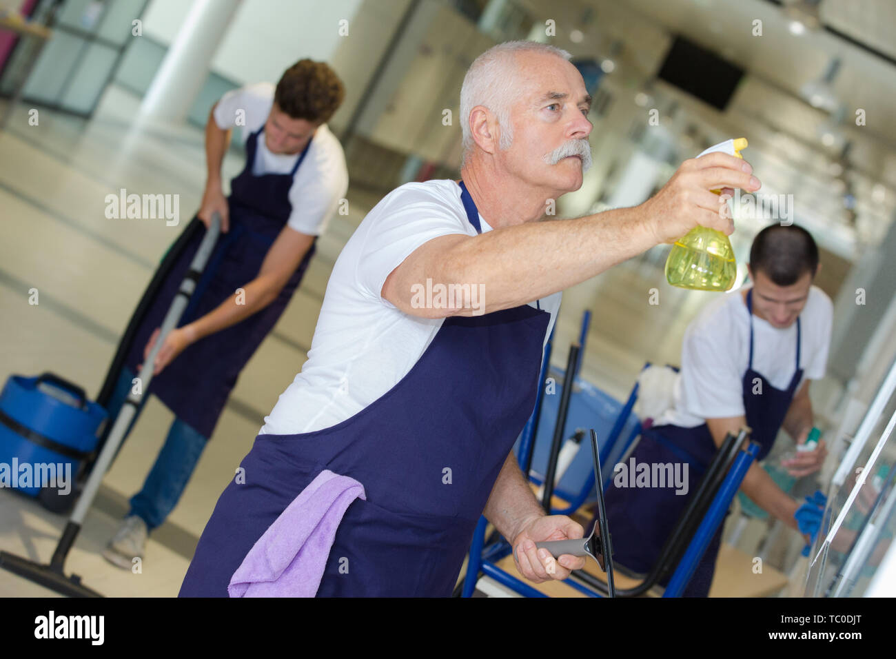 male cleaning team at work senior operative spraying product Stock ...
