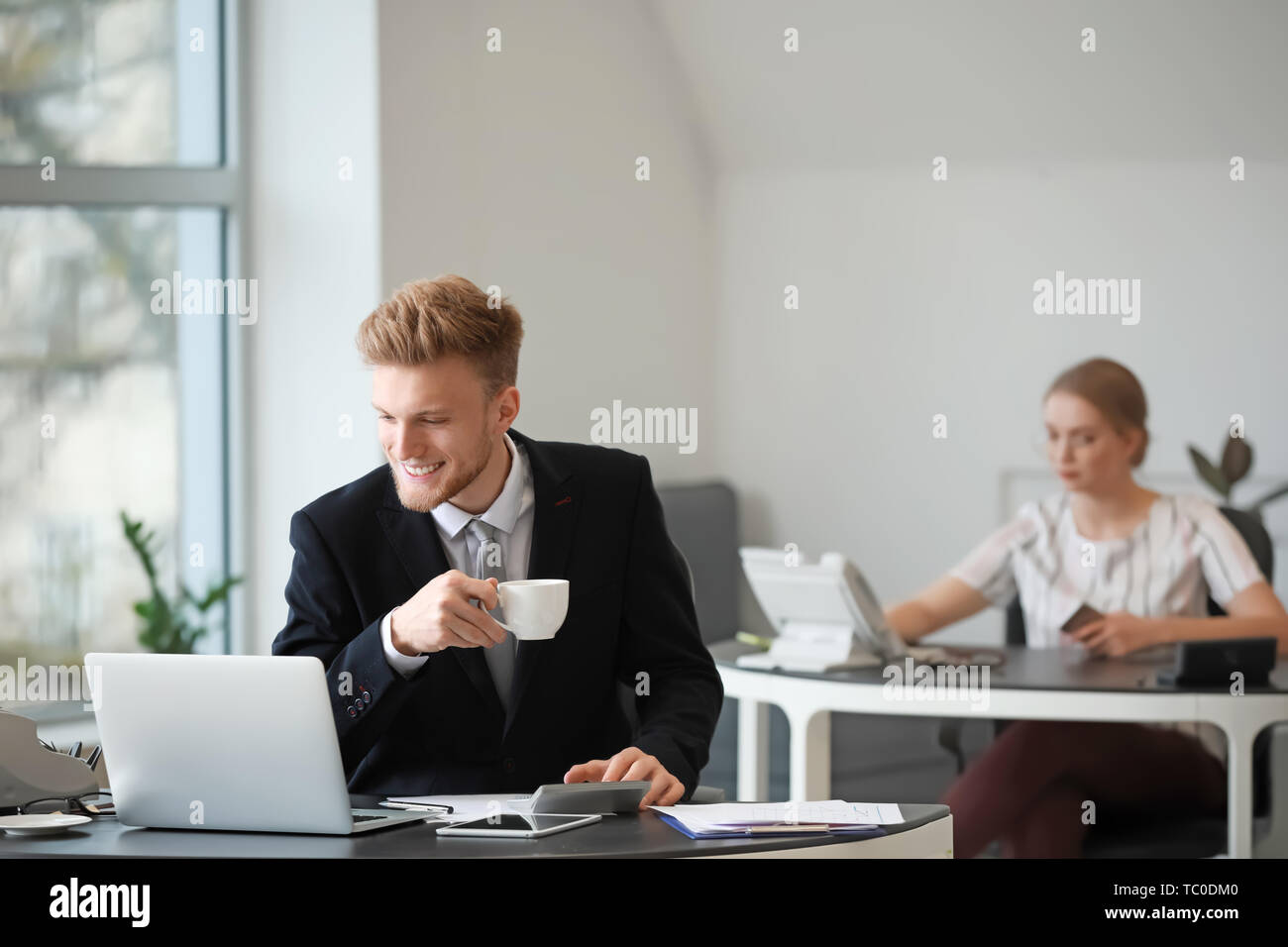 Male accountant working in office Stock Photo - Alamy