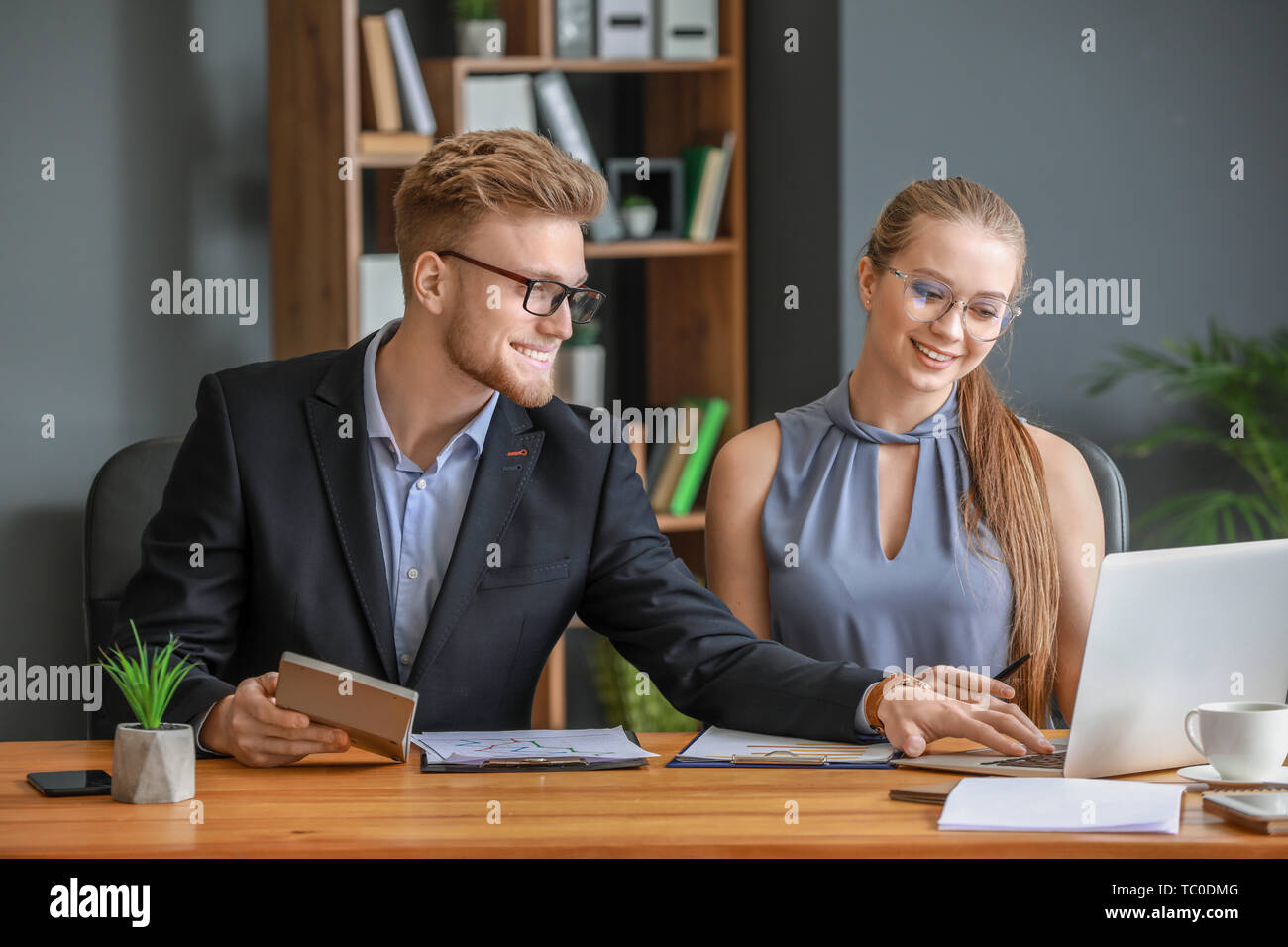 Male and female accountants working in office Stock Photo - Alamy