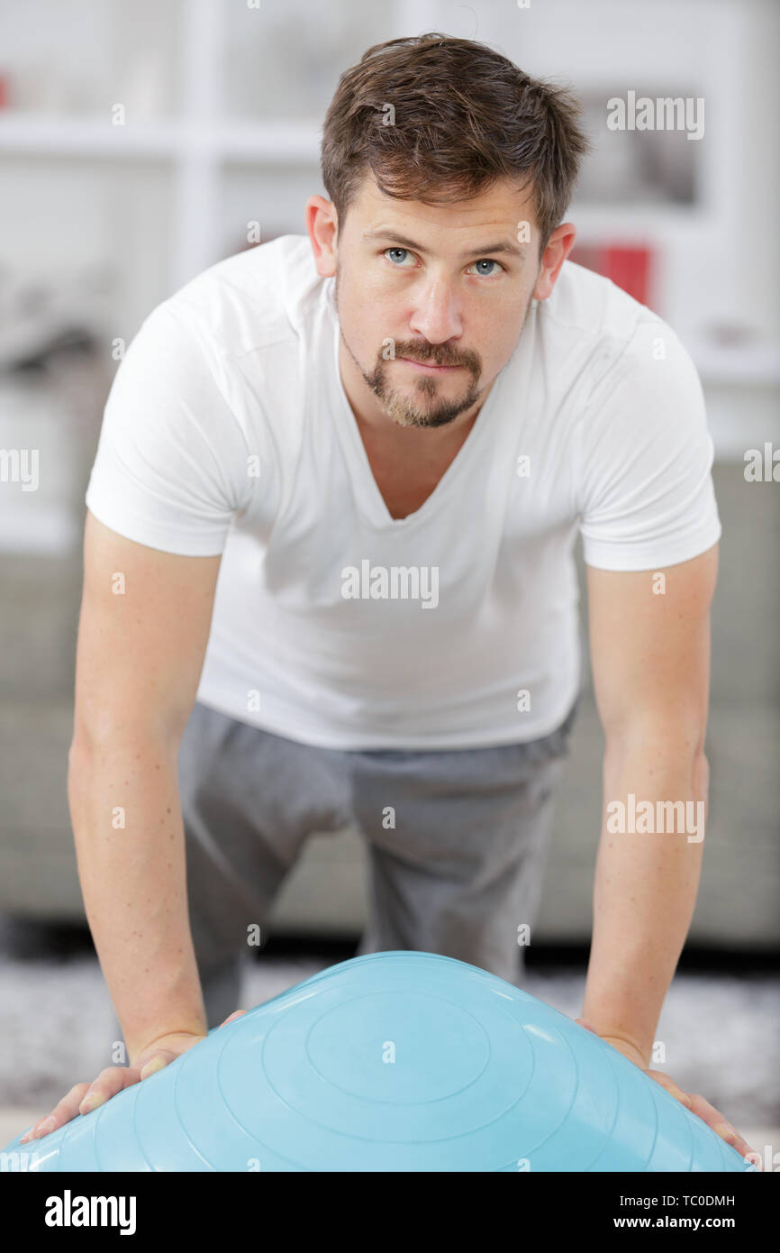 healthy man doing side plank exercise on a mat Stock Photo - Alamy