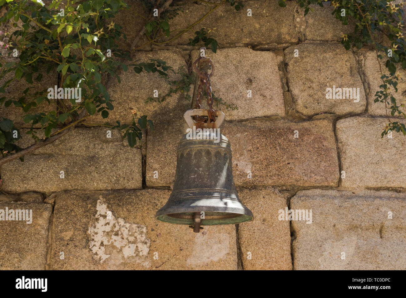 Ancient bell on a stone wall in the abandoned village of Granadilla ...