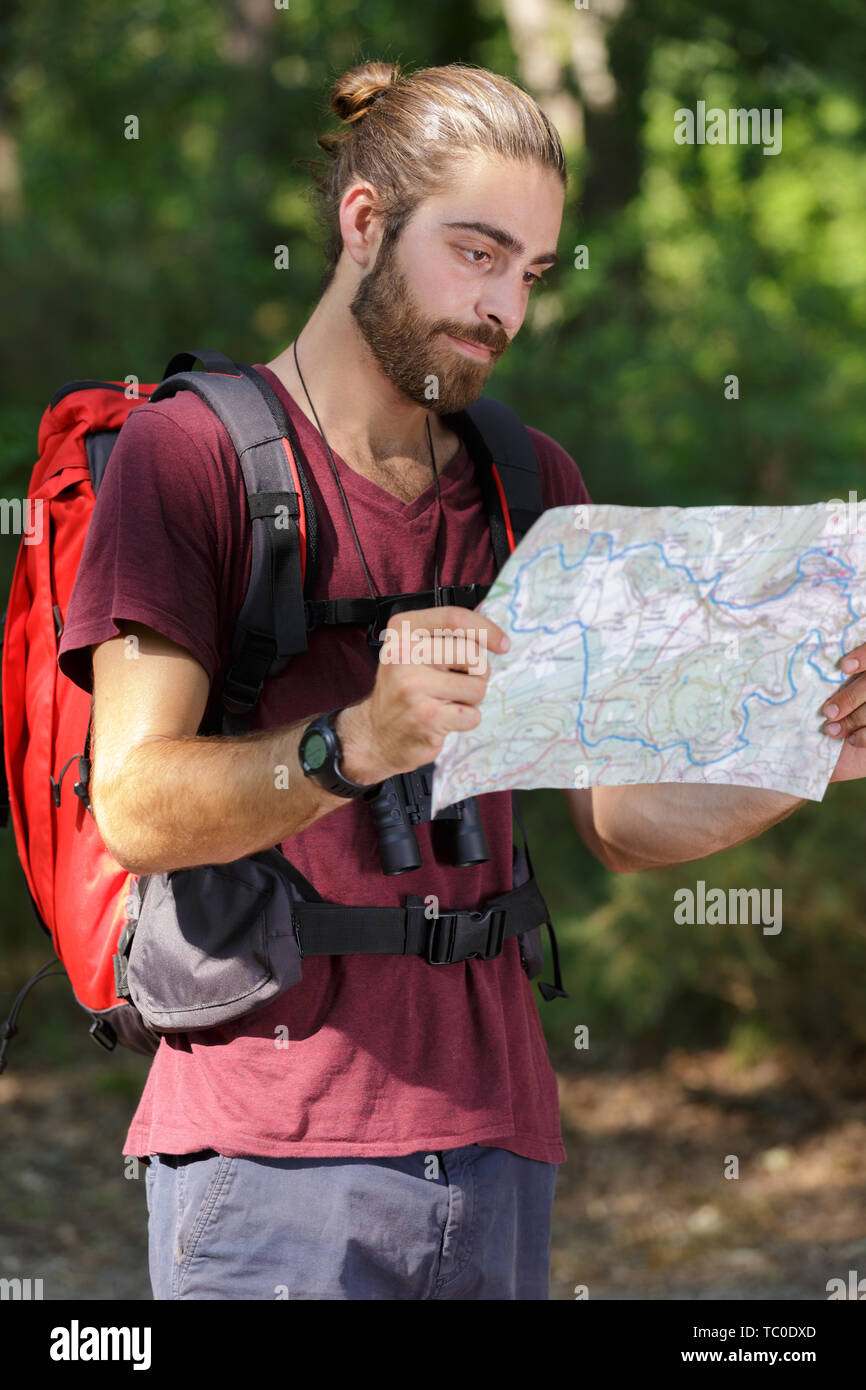 male nature explorer reading nthe map Stock Photo - Alamy
