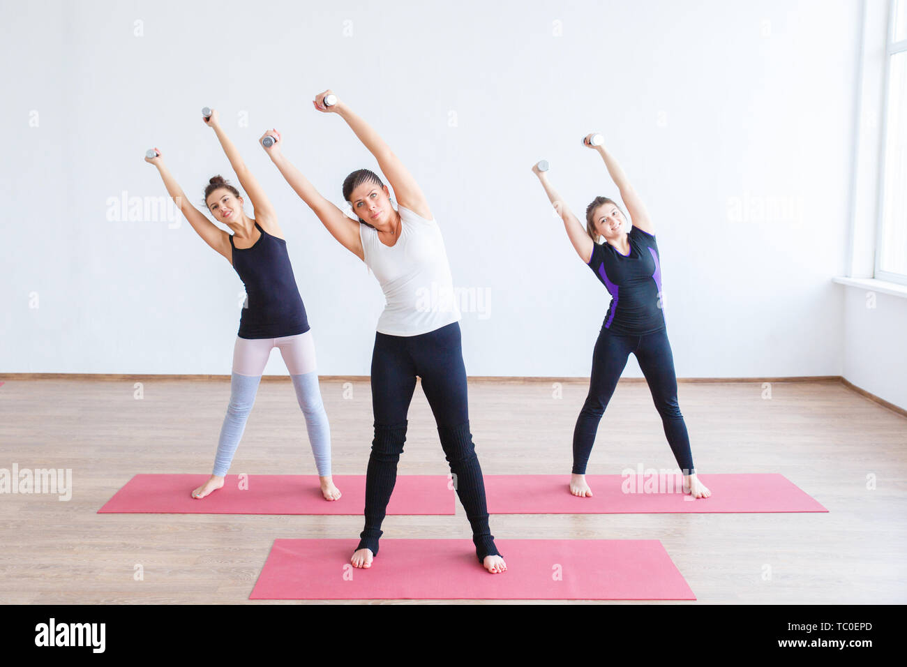 Group of people doing exercises in gym Stock Photo - Alamy