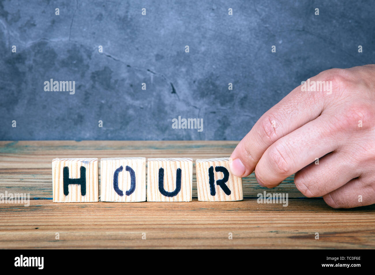 Hour - word from wooden letters Stock Photo - Alamy