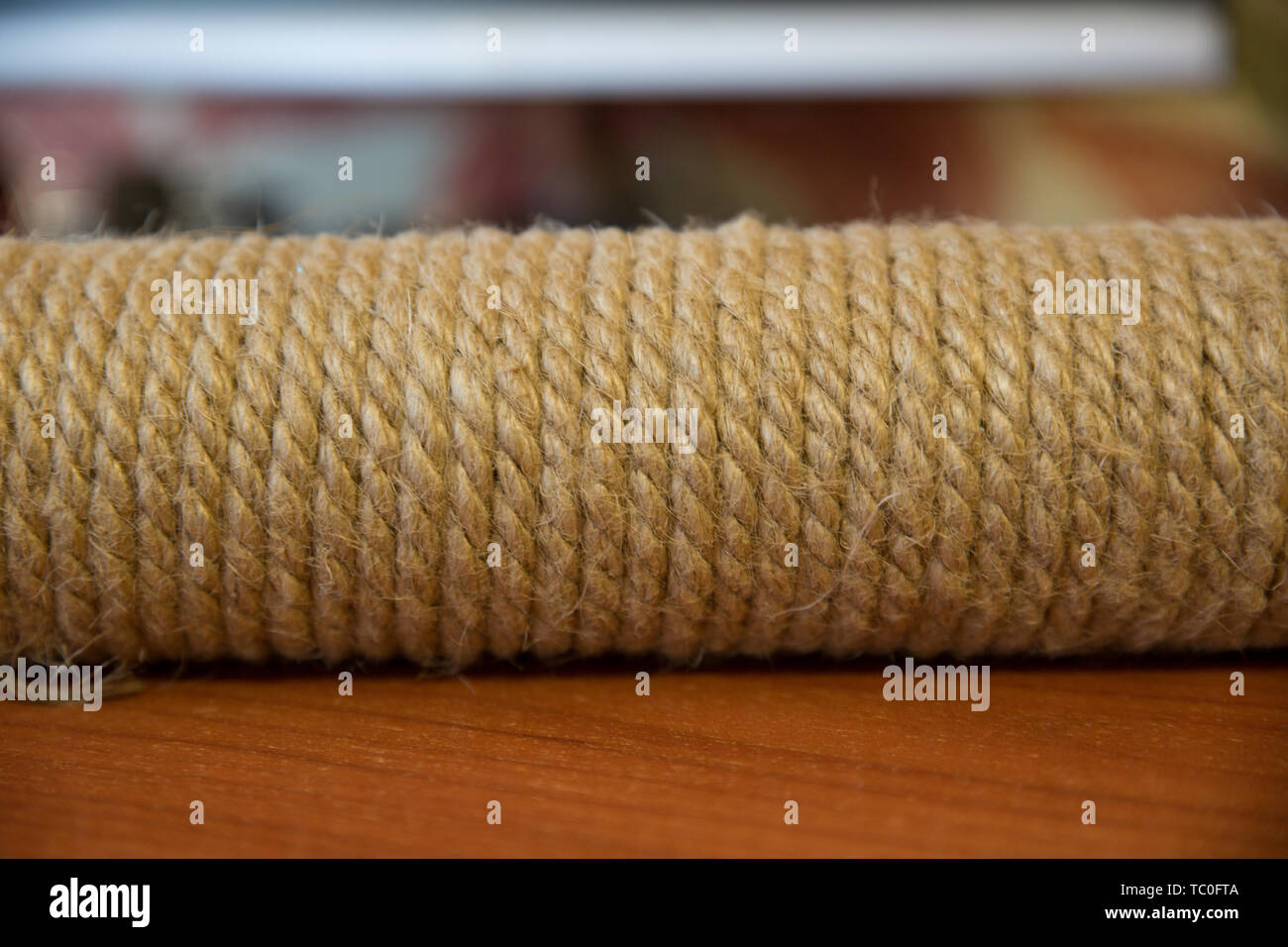 Rope tightly wound on a pipe for sharpening the claws of cats in a ...