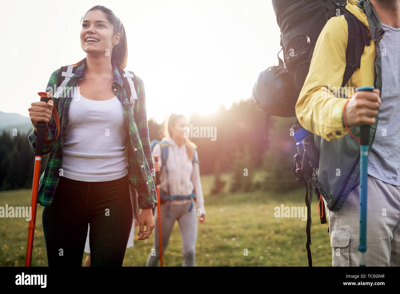 Hiking with friends is so fun. Group of young people with backpacks ...
