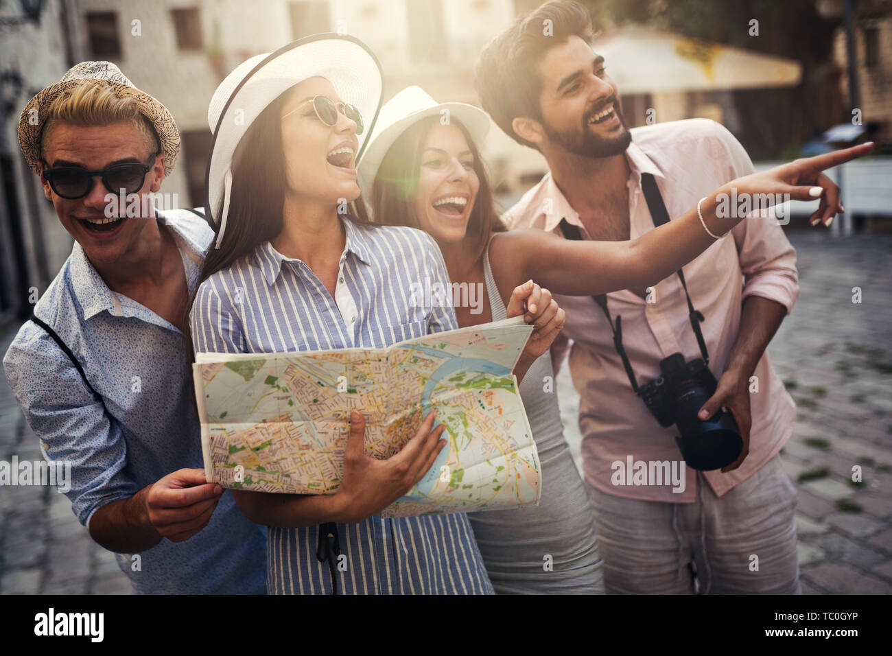 Happy group of tourists traveling and sightseeing together at summer ...