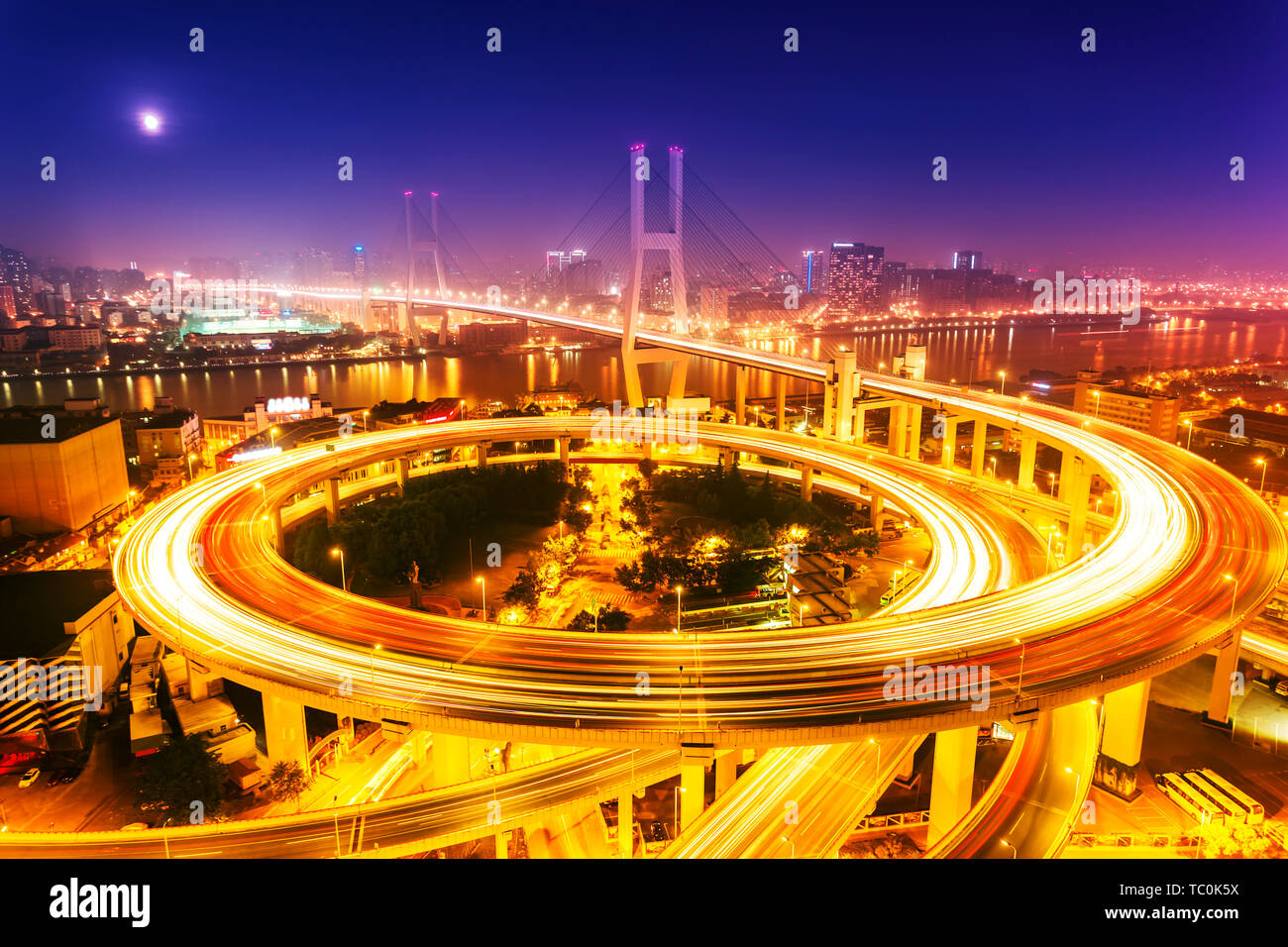 illuminated road intersection and traffic trails Stock Photo - Alamy