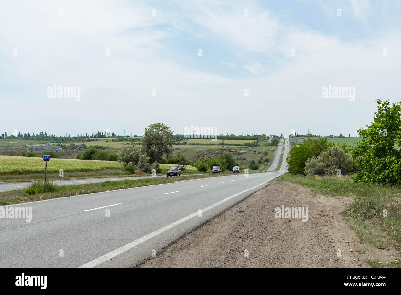 Summer highway against the blue sky. Rise and descent Stock Photo - Alamy