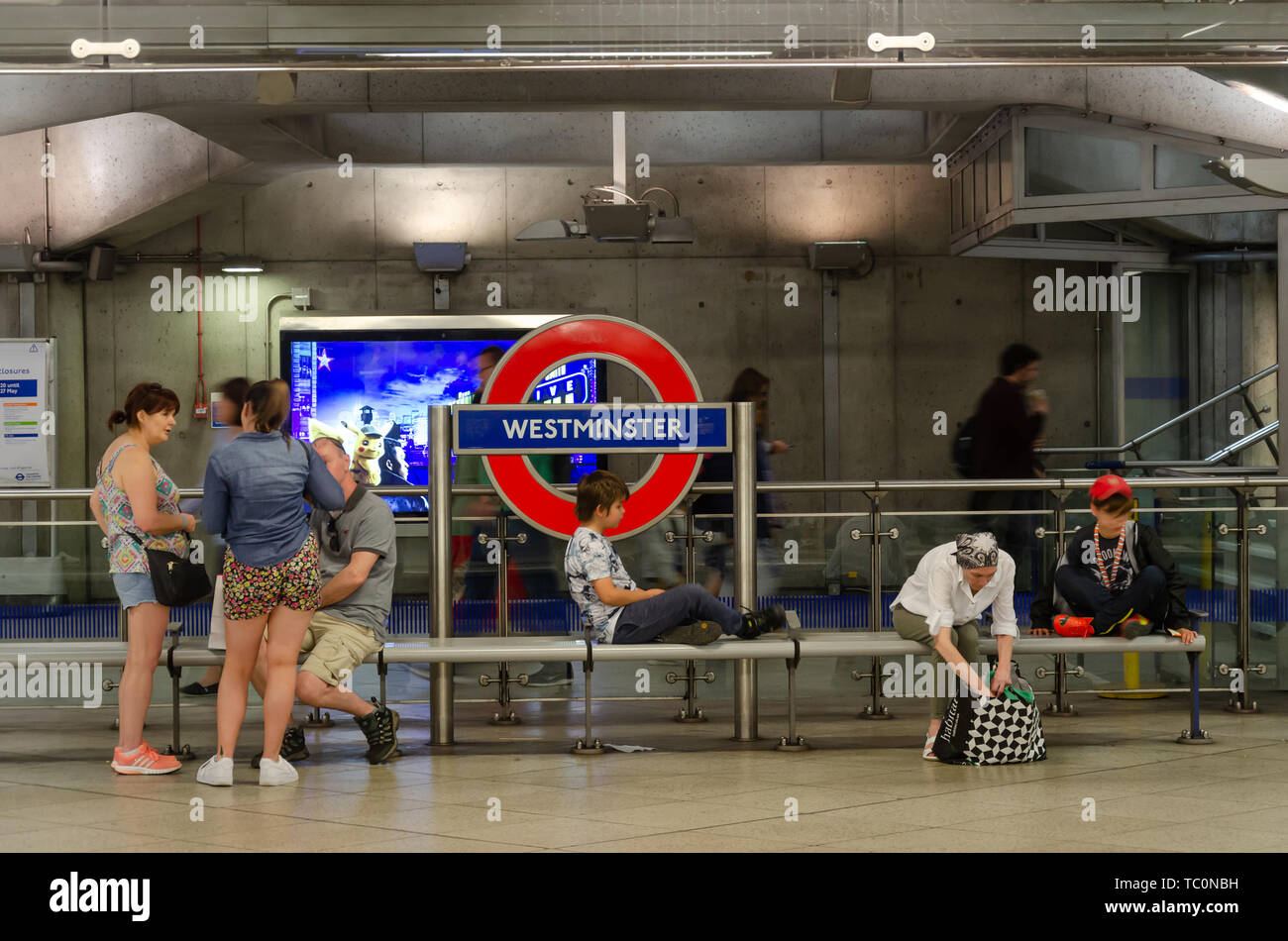 Passengers wait on the platform at westminster underground station hi ...