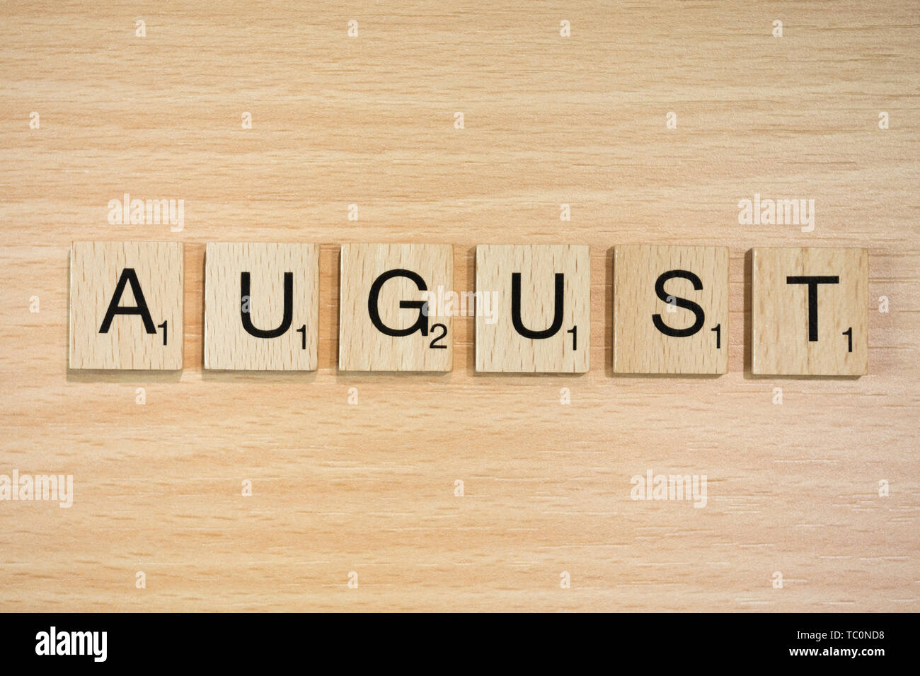 The word March, spelt out using wooden tiles on a wood effect ...