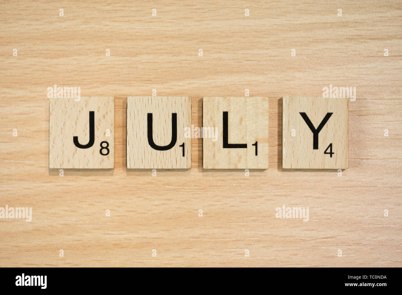 The word March, spelt out using wooden tiles on a wood effect ...