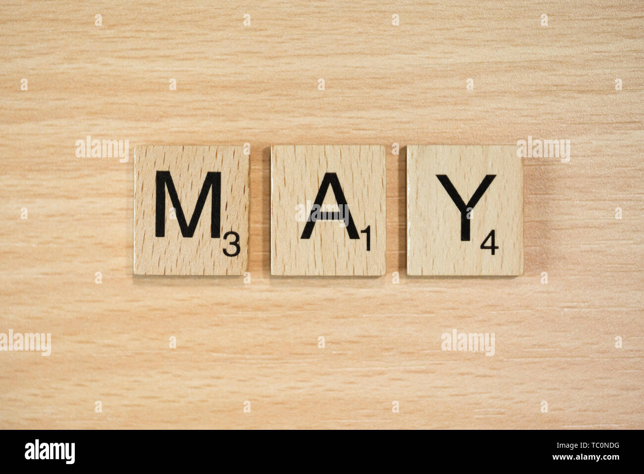 The word March, spelt out using wooden tiles on a wood effect ...