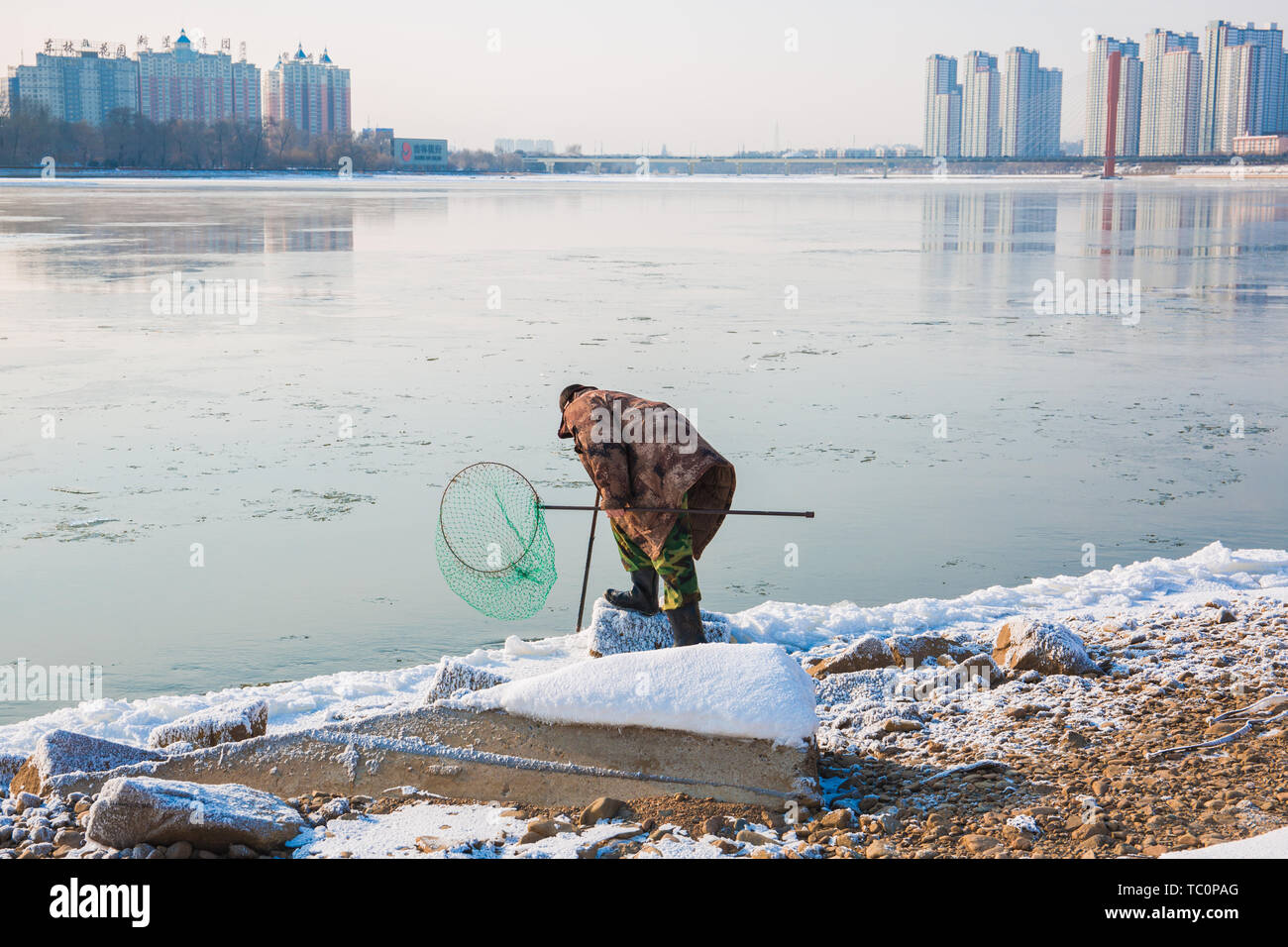 Fishing in frozen rivers Stock Photo - Alamy