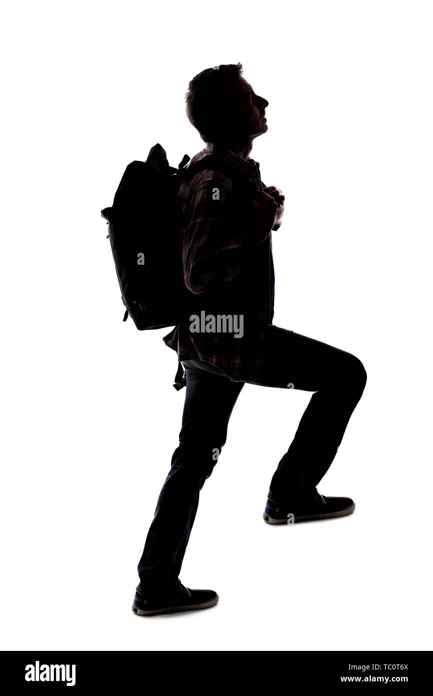 Silhouette of a hiker or mountain climber reaching to move up an ...