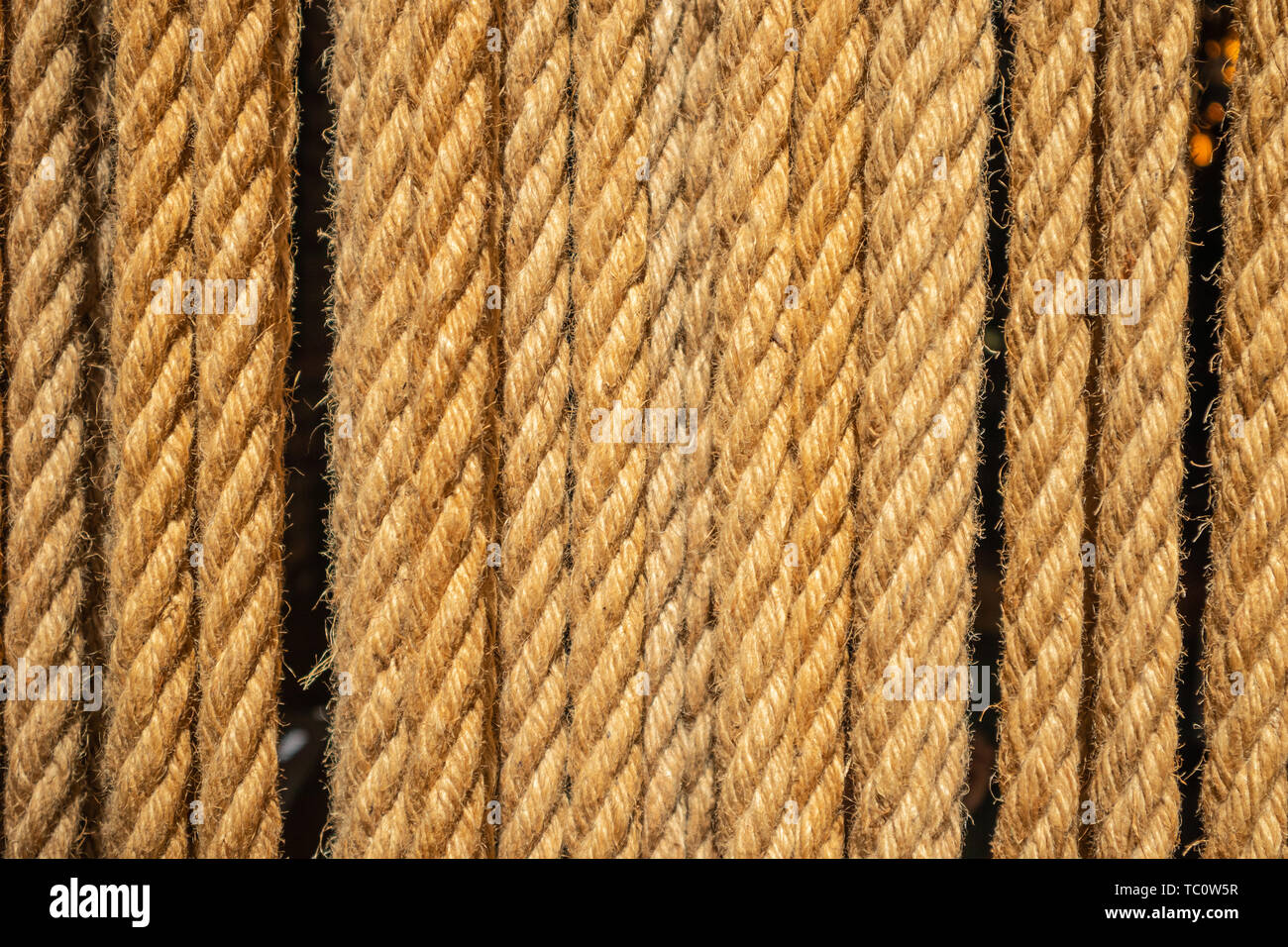 Vertical ropes, tether in row background. Brown twisted cord backdrop ...