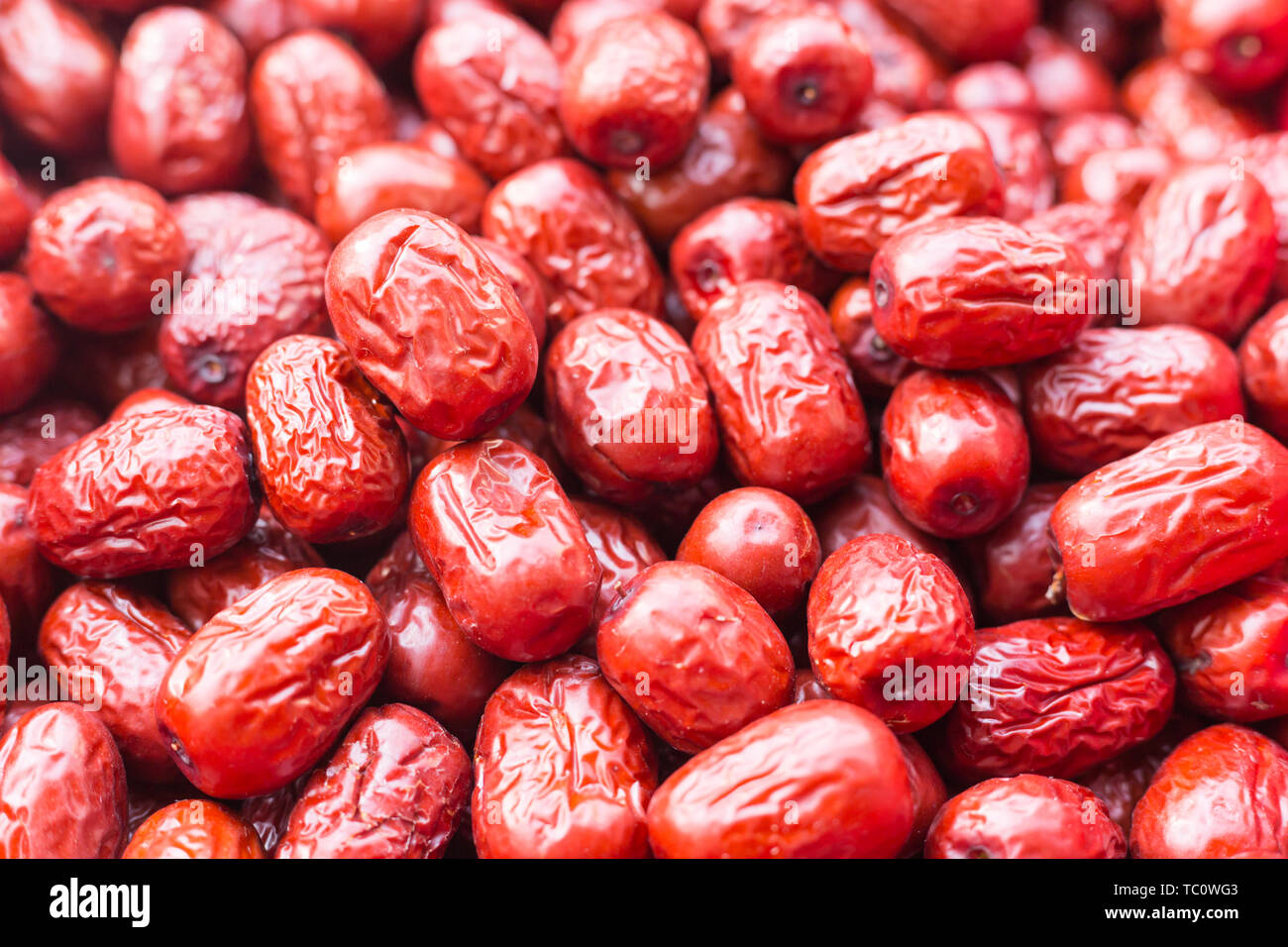 Red dates all over the table Stock Photo - Alamy