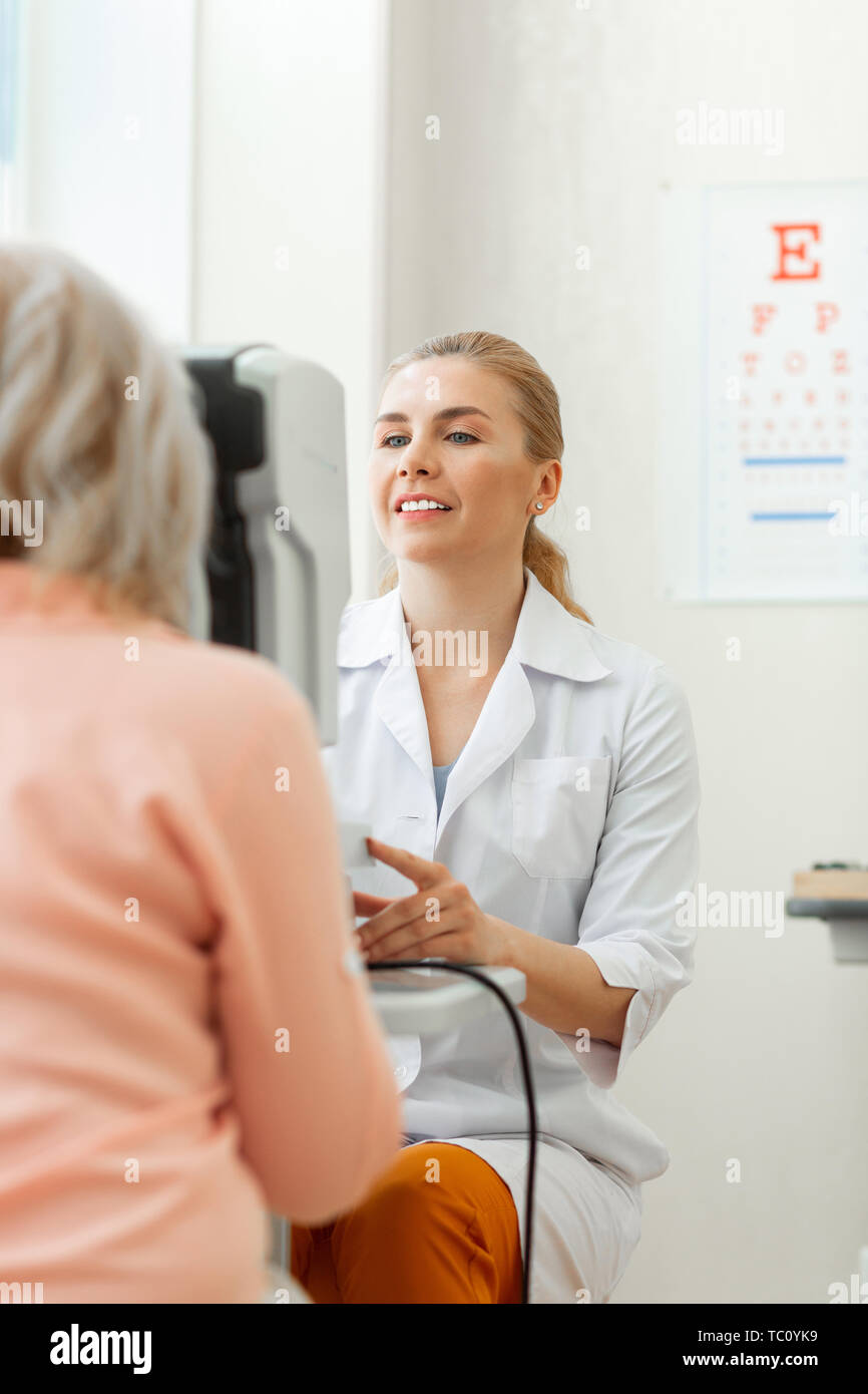 Visual inspection. Beaming positive doctor dealing with complicated ...