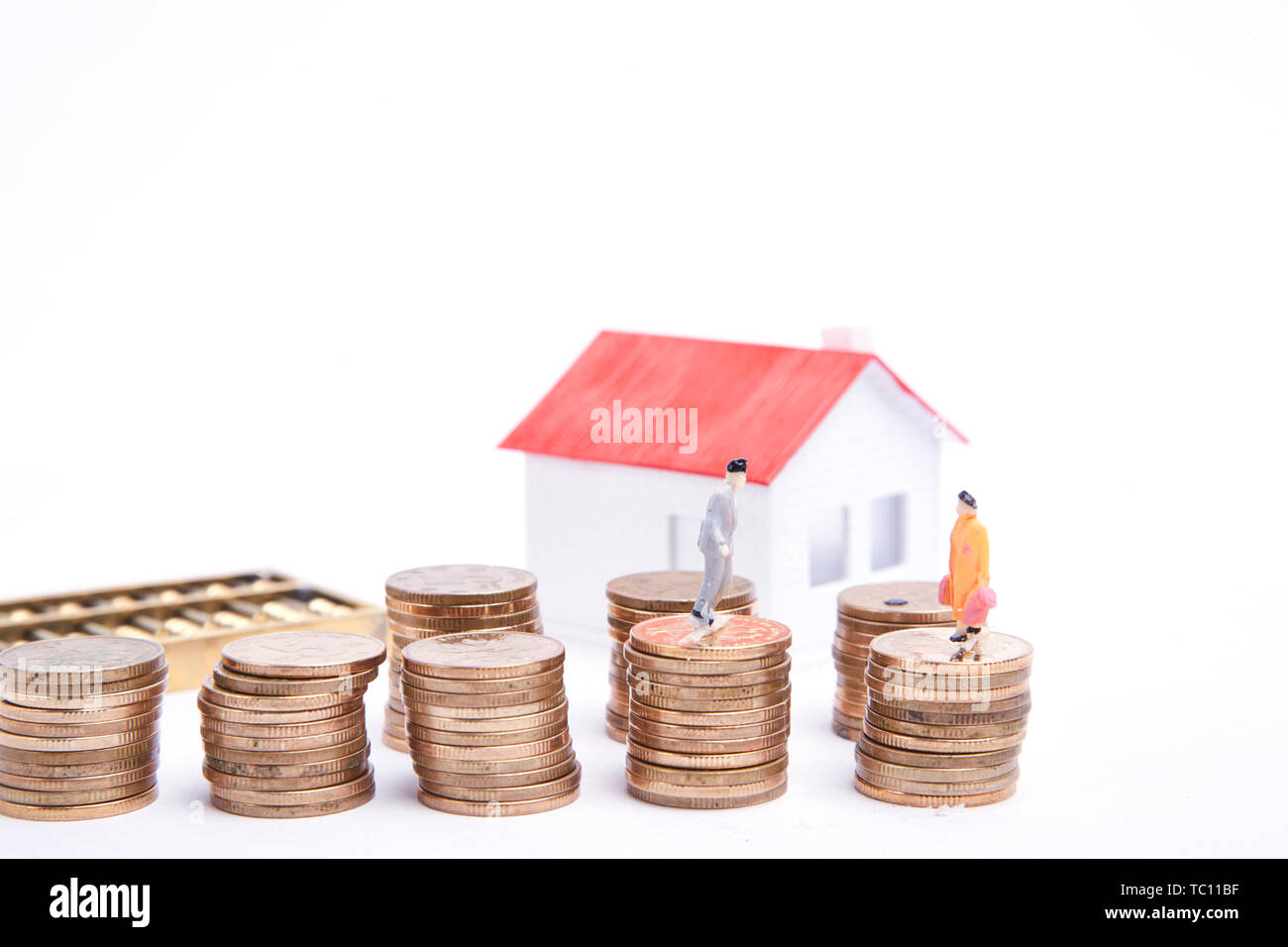 Coin house model and couple on white background Stock Photo - Alamy