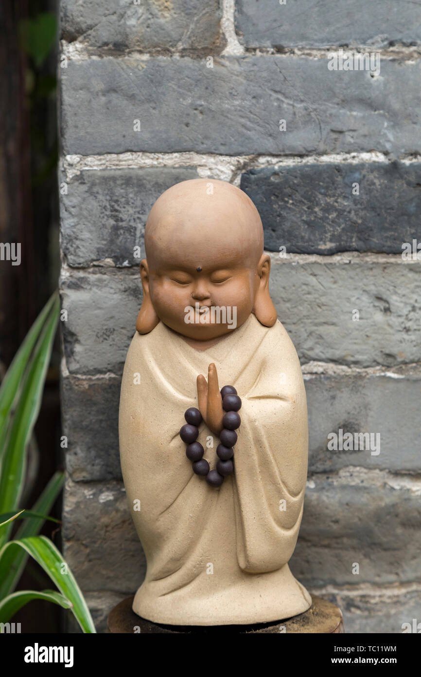Little monk statue Stock Photo - Alamy
