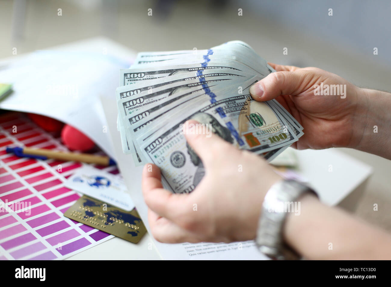 Male hands counting money from huge pack Stock Photo - Alamy