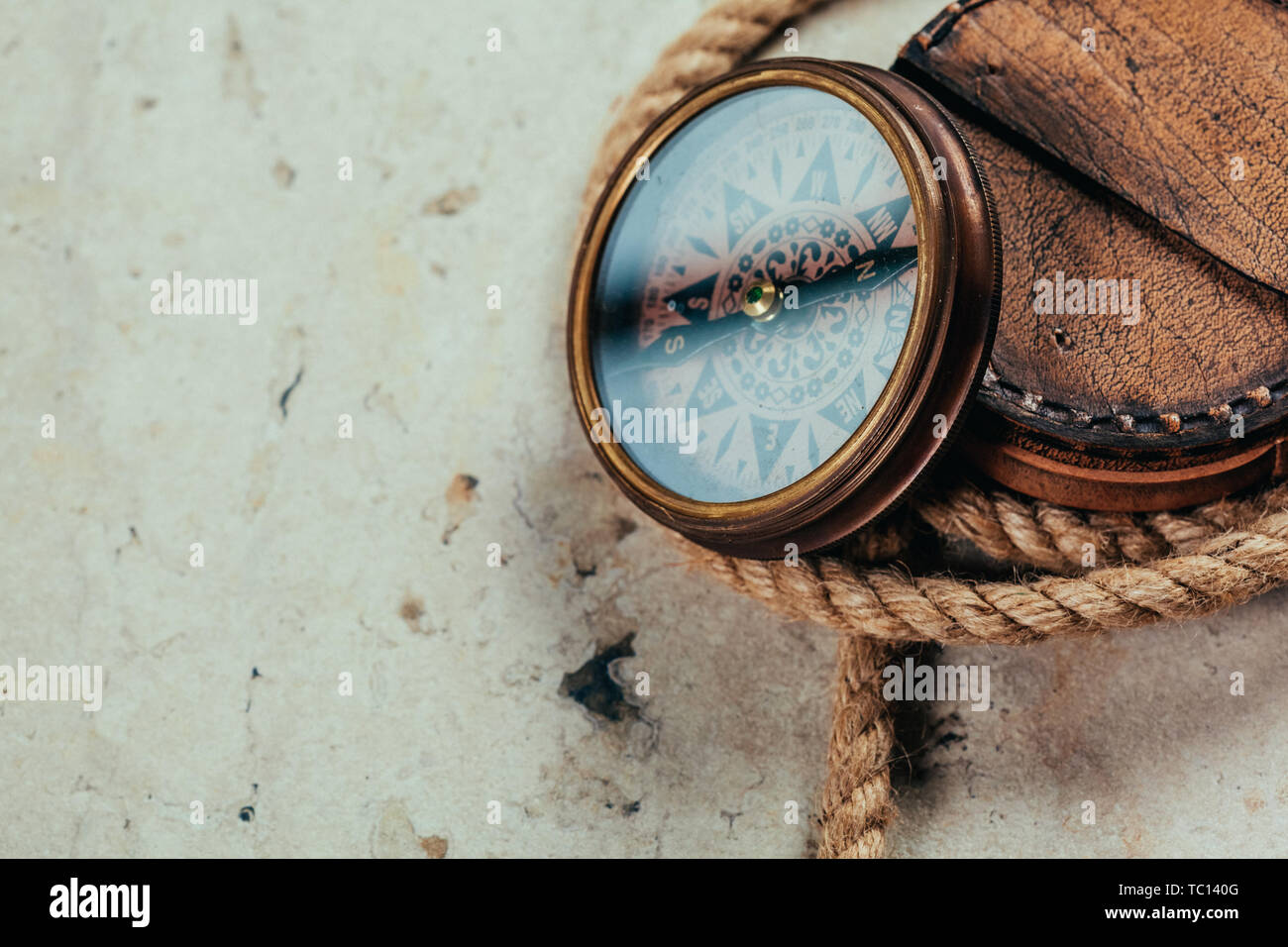 Compass on a gray gradient background Stock Photo - Alamy