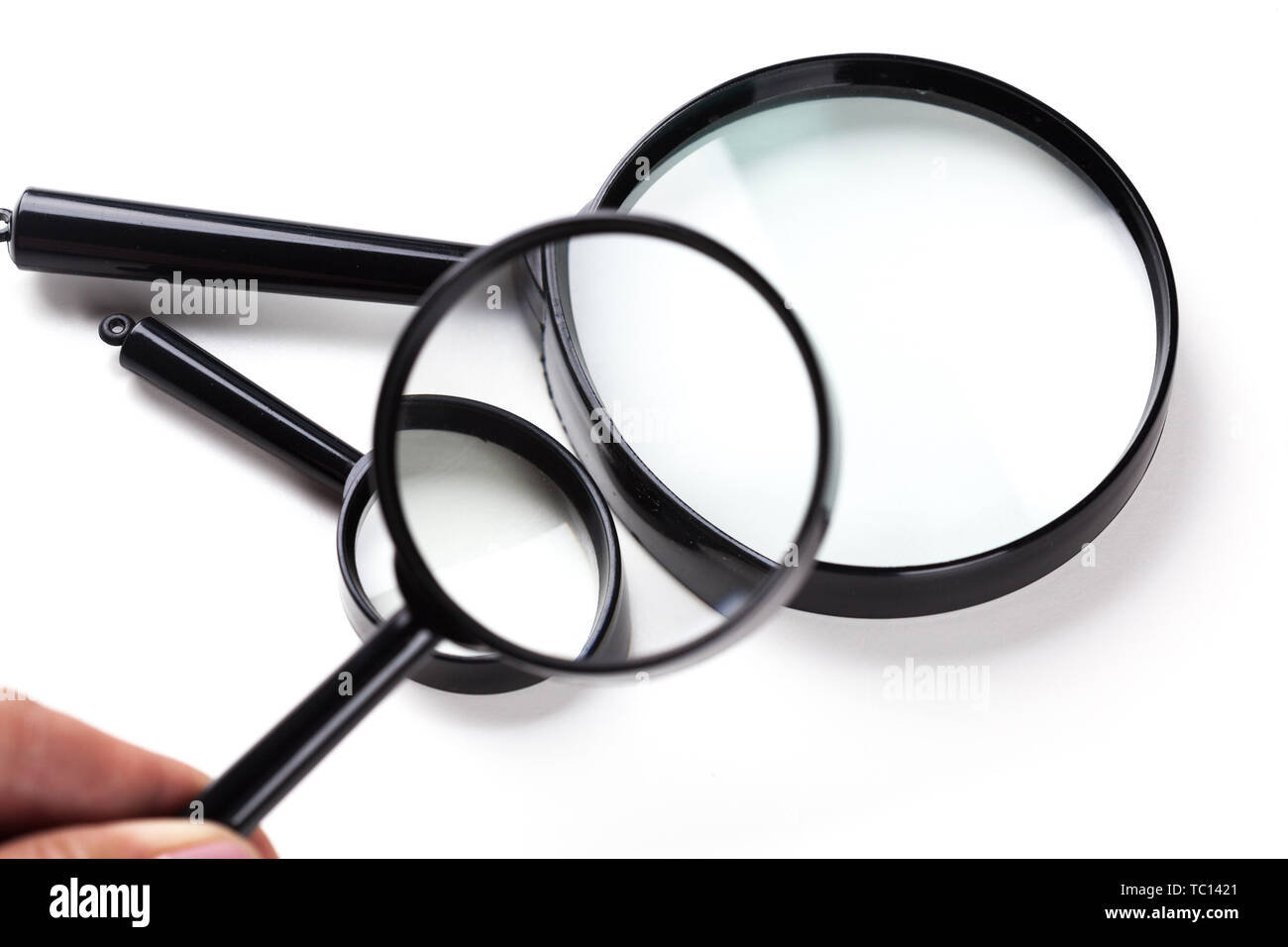 Three magnifiers over white Stock Photo - Alamy