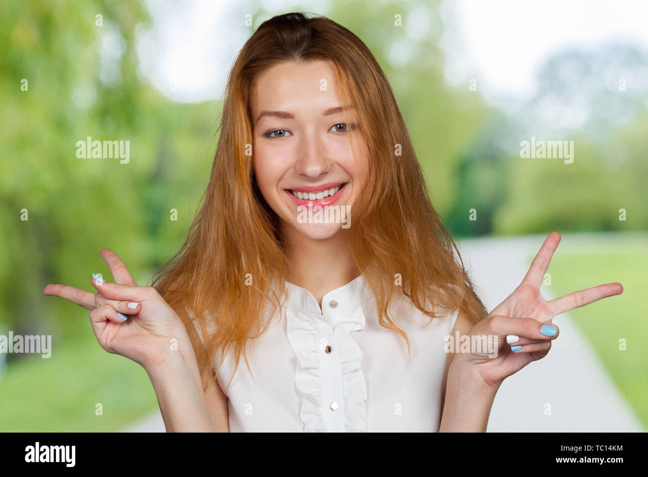 Closeup portrait of happy, excited successful young woman giving peace ...