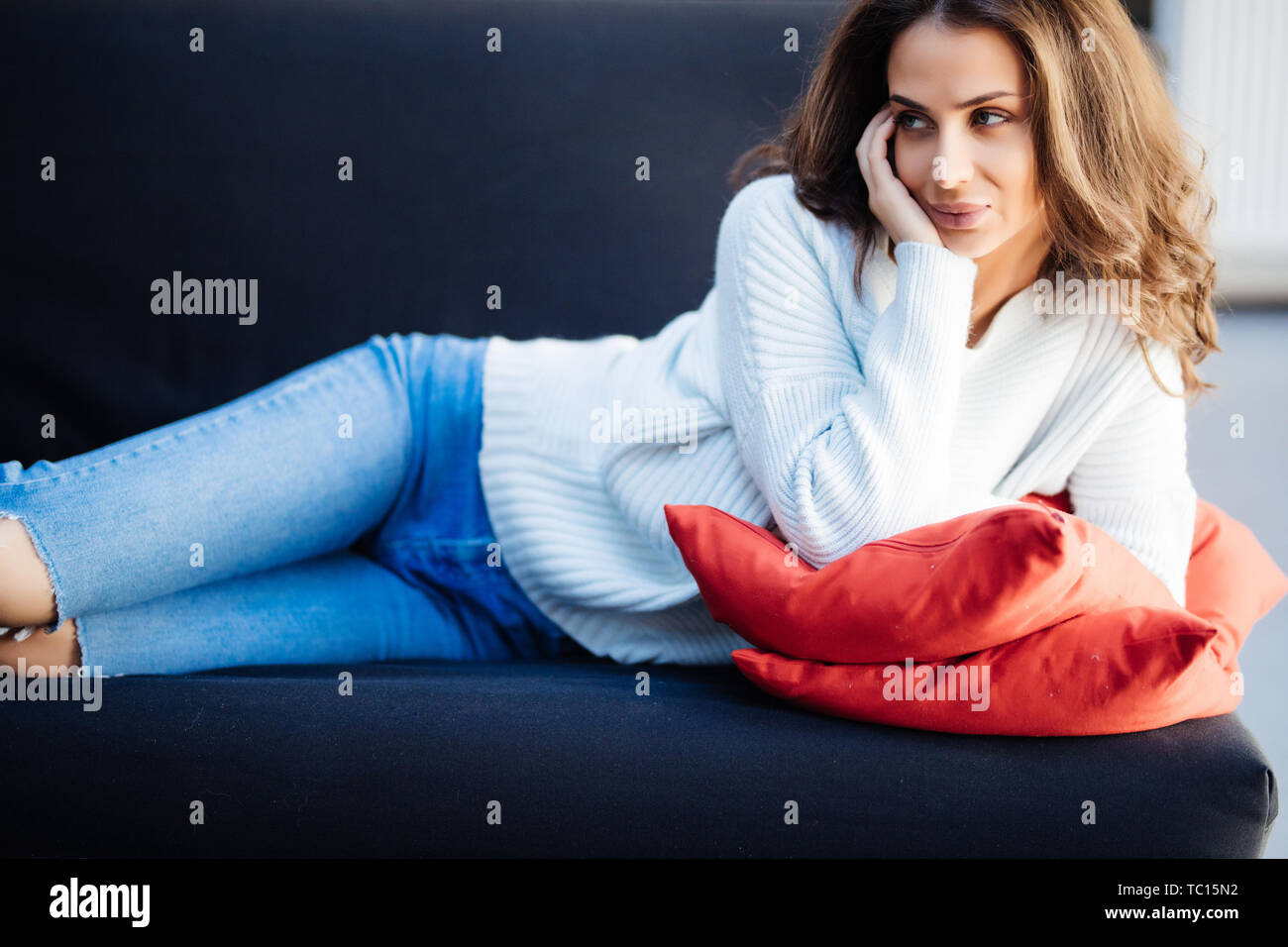 Young smile woman relaxing on her couch Stock Photo - Alamy