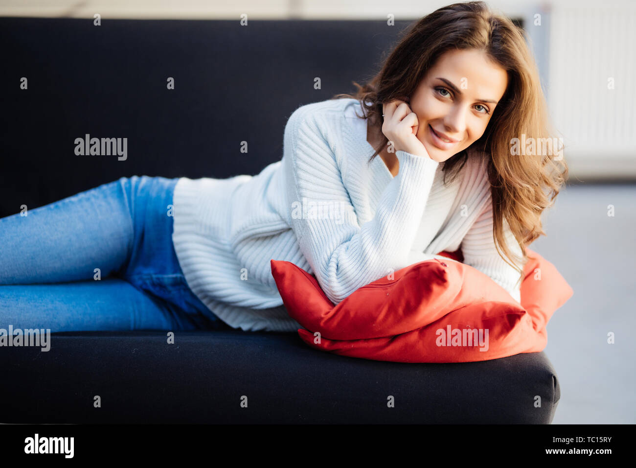 Young smile woman relaxing on her couch Stock Photo - Alamy