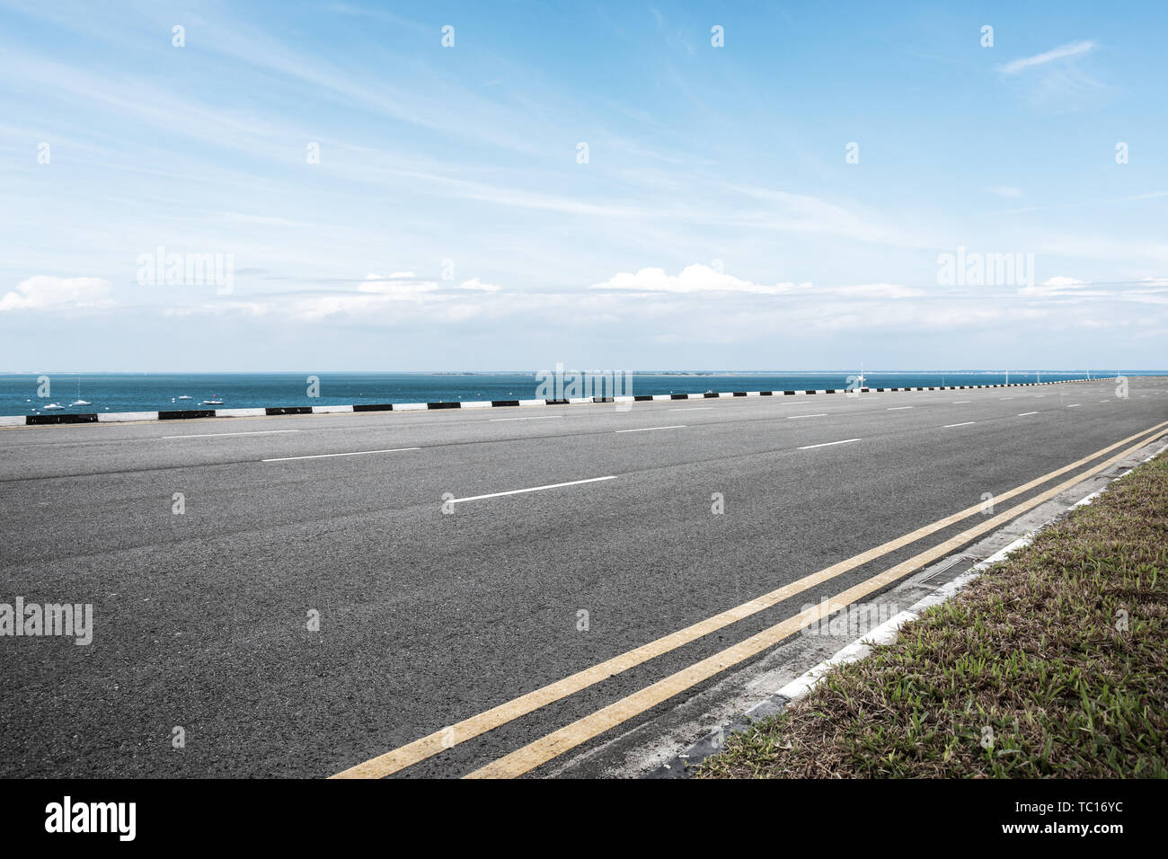 empty asphalt road and blue sea in blue sky Stock Photo - Alamy