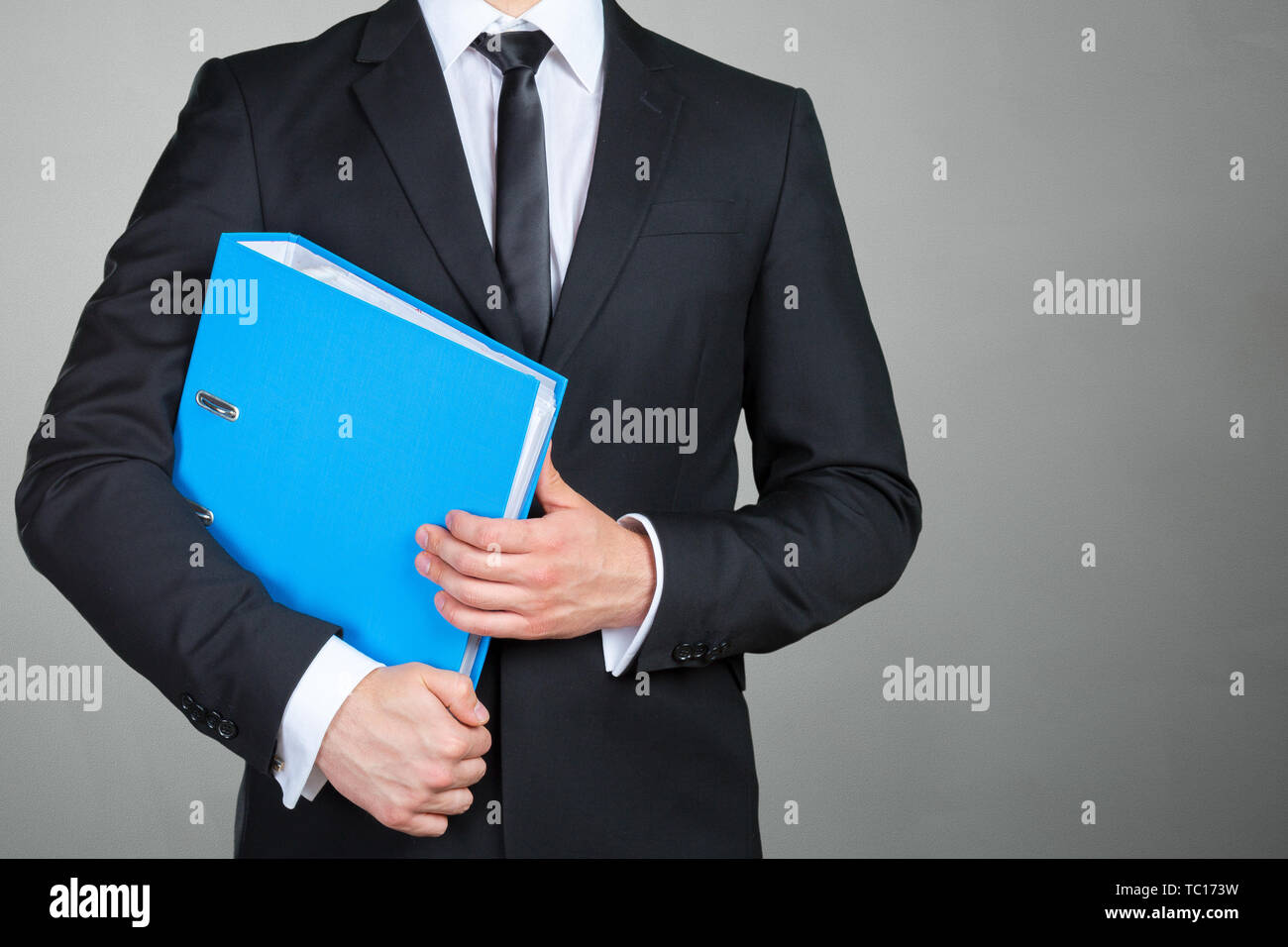 Confident businessman holding a document folder Stock Photo - Alamy