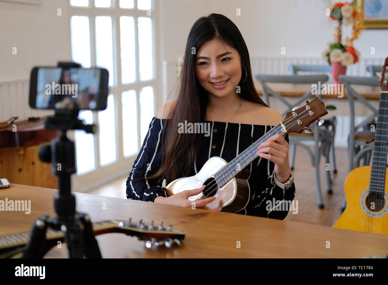 blogger live broadcasting music instrument tutorial on social media. vlogger recording online ...