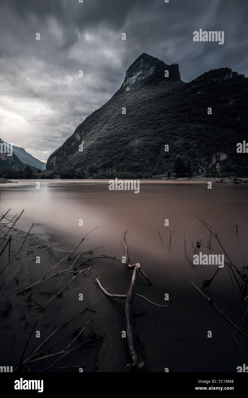 The withered branches and mountains by the water Stock Photo - Alamy