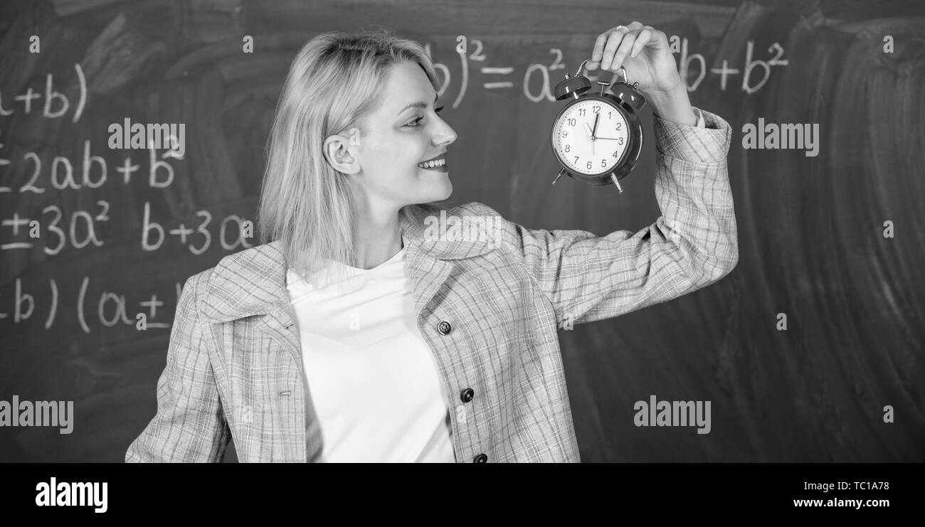 Always on time. Woman teacher hold alarm clock. She cares about ...