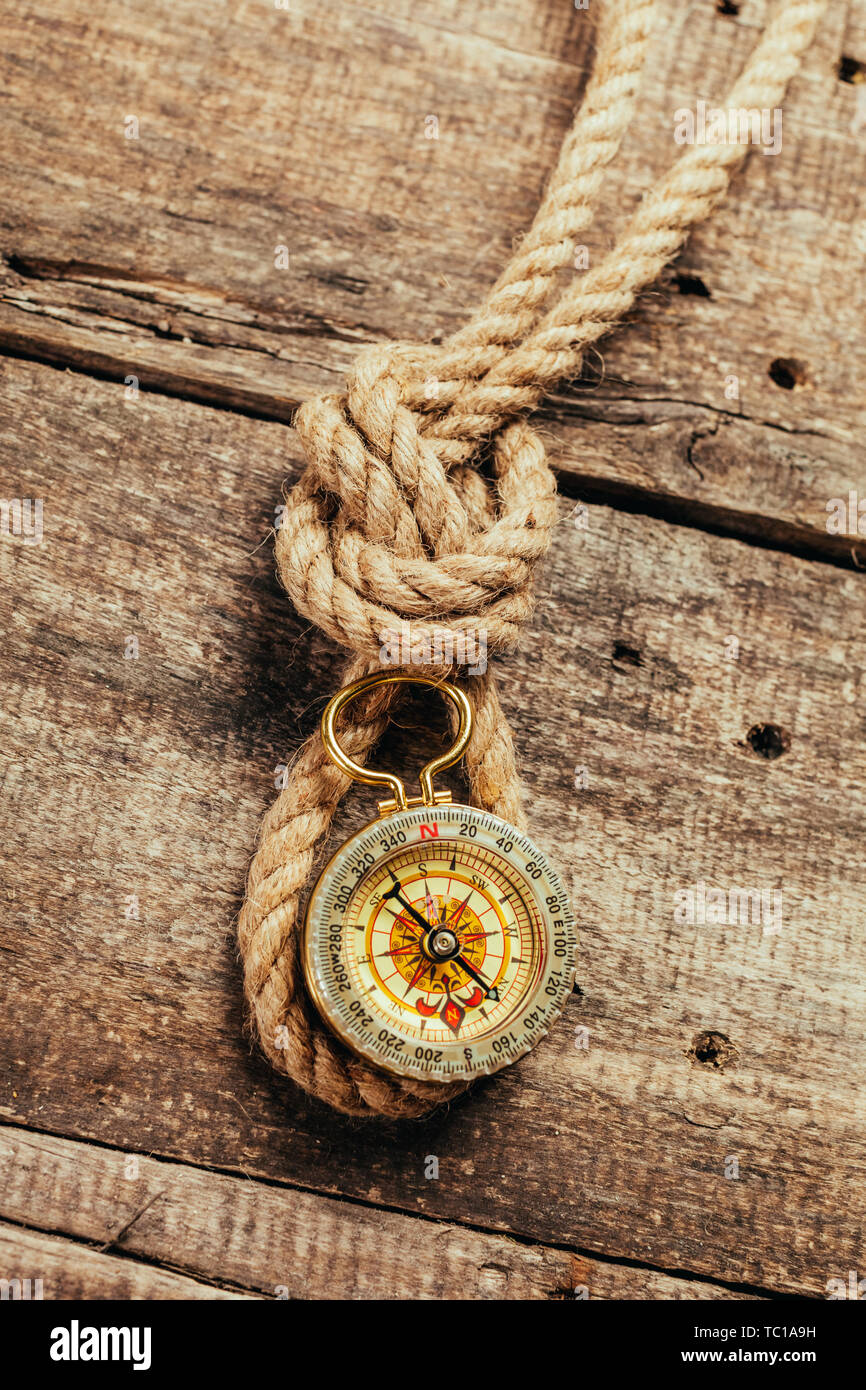ship ropes and compass on wooden background Stock Photo - Alamy