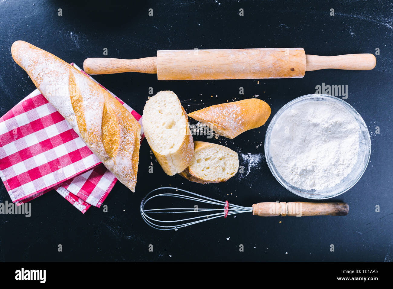 Baking dark background with blank cook book, eggshell, bread, flour ...