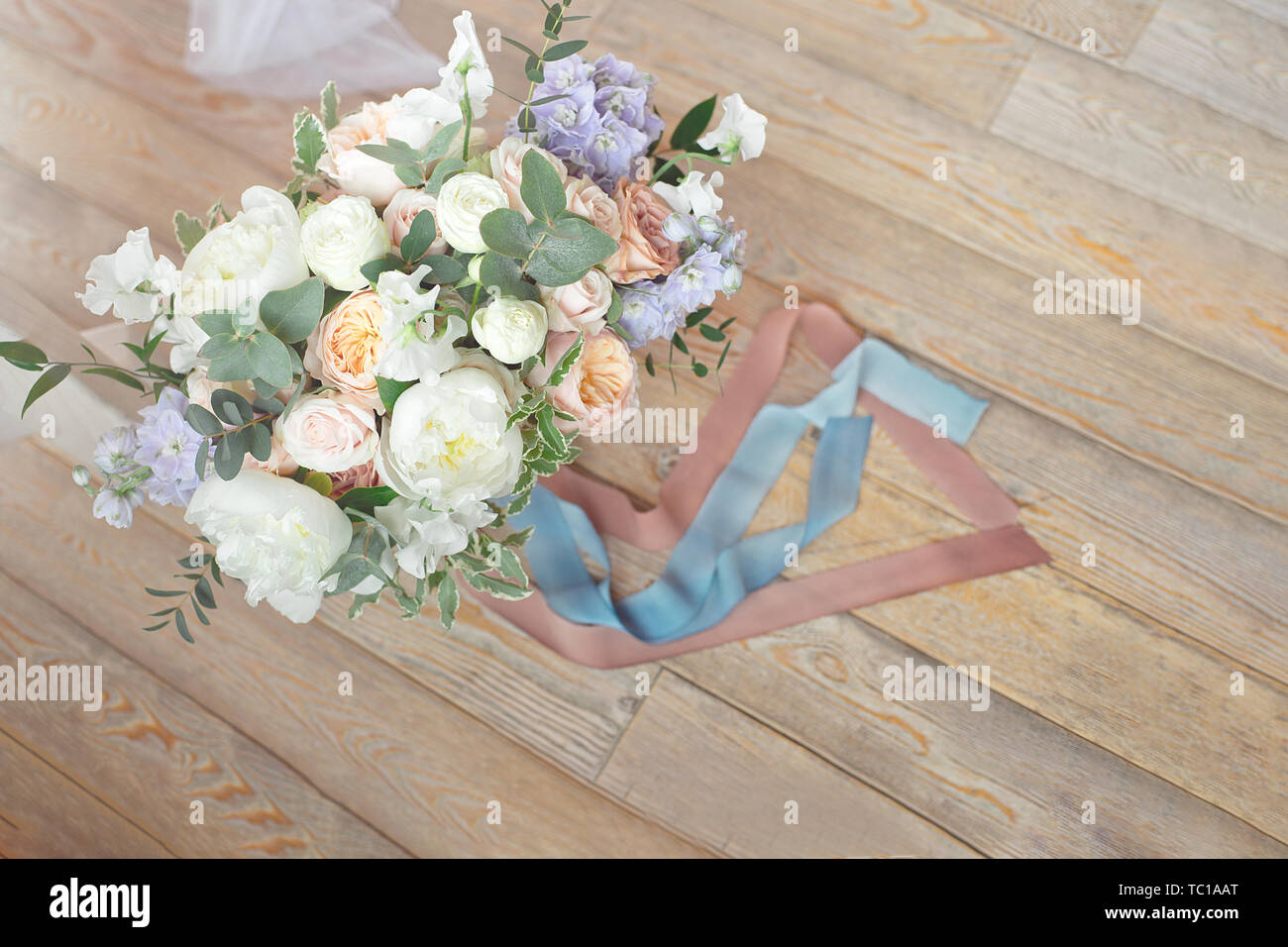 Close-up bouquet of roses peonies freesia dianthus flowers on the round ...