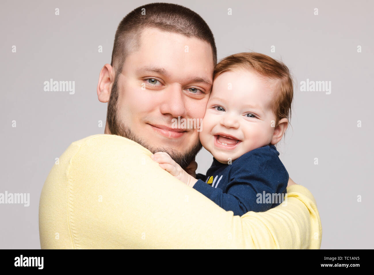 Portrait of happy father posing with lovely smiling child Stock Photo - Alamy