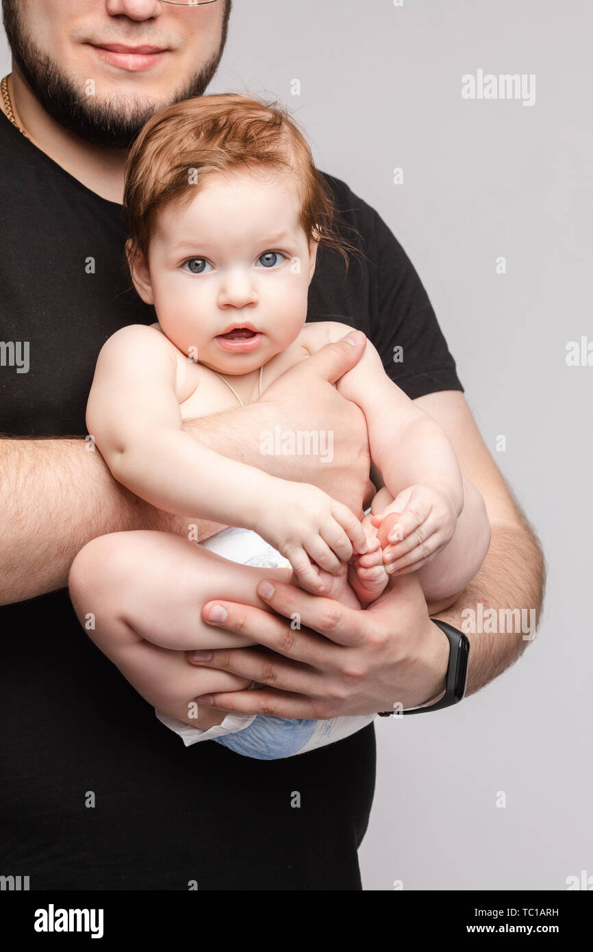 Father keeping little baby in hands and kissing kid Stock Photo - Alamy