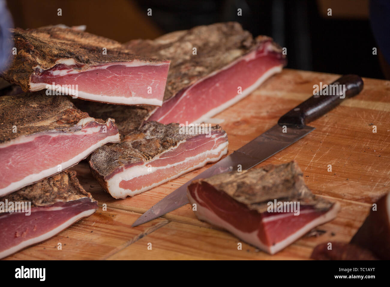 Traditional smoked speck sliced on site during the "Speckfest ...