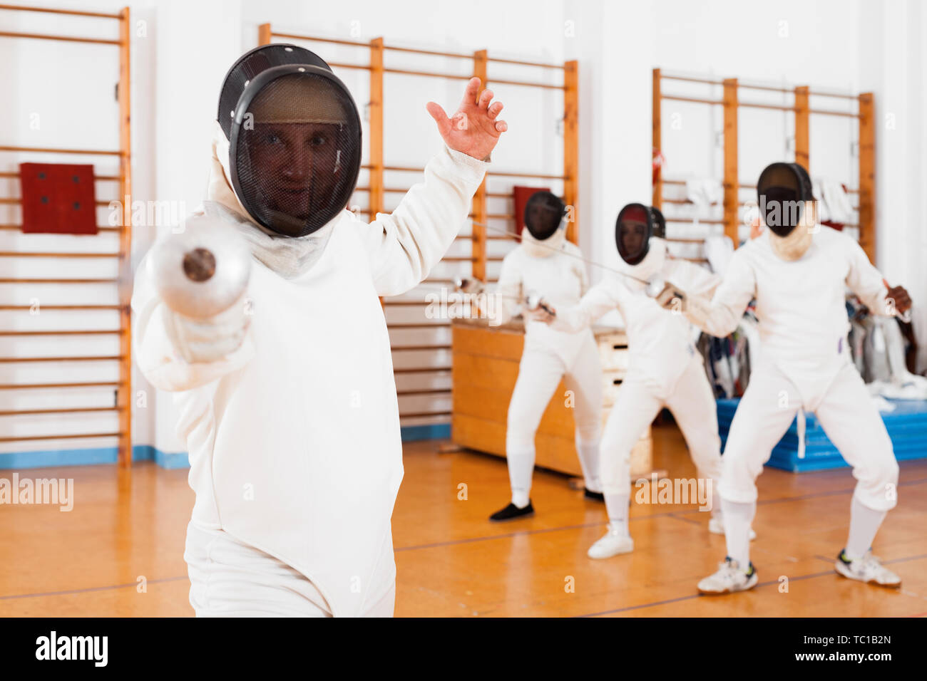 Sporty young glad cheerful positive man fencer practicing effective ...