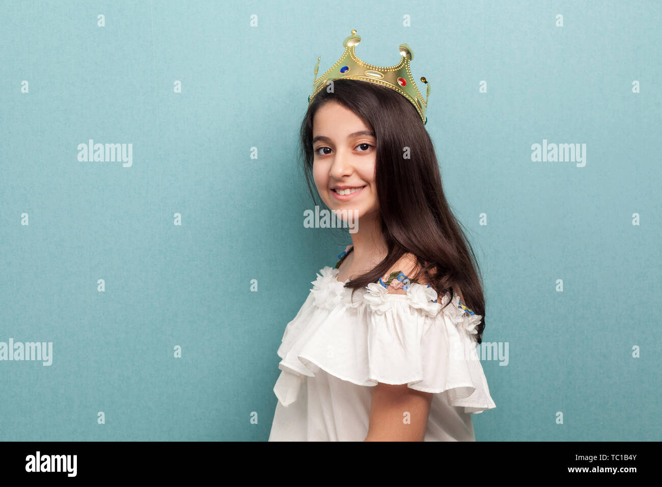 Side view portrait of beautiful little princess brunette girl wear in ...