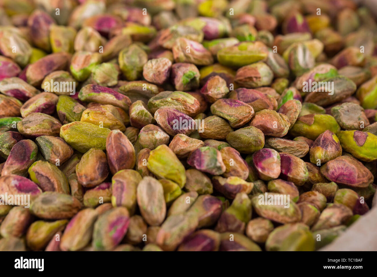 Image of green pistachios in container in the store Stock Photo - Alamy