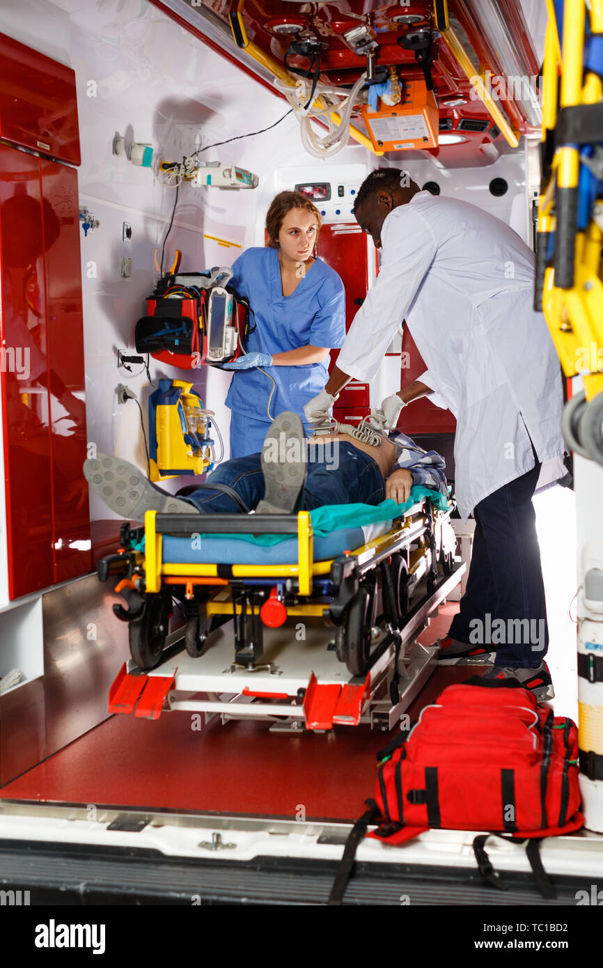 Efficient diligent serious emergency doctor resuscitating male patient ...