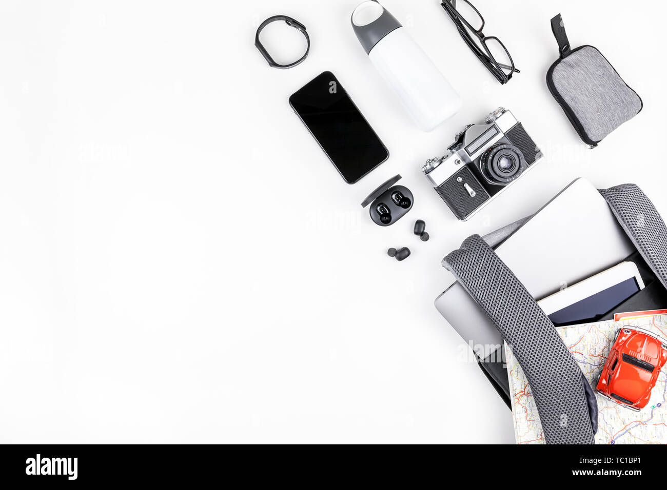 Creative top view flat lay of open backpack with laptop and tablet ...