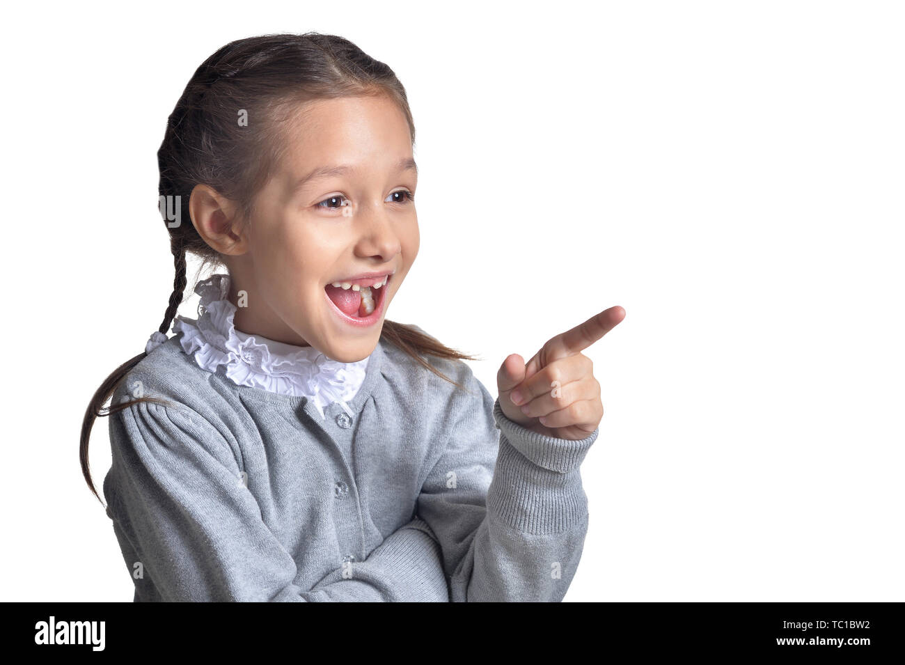 Cute little girl pointing to the right isolated on white background ...