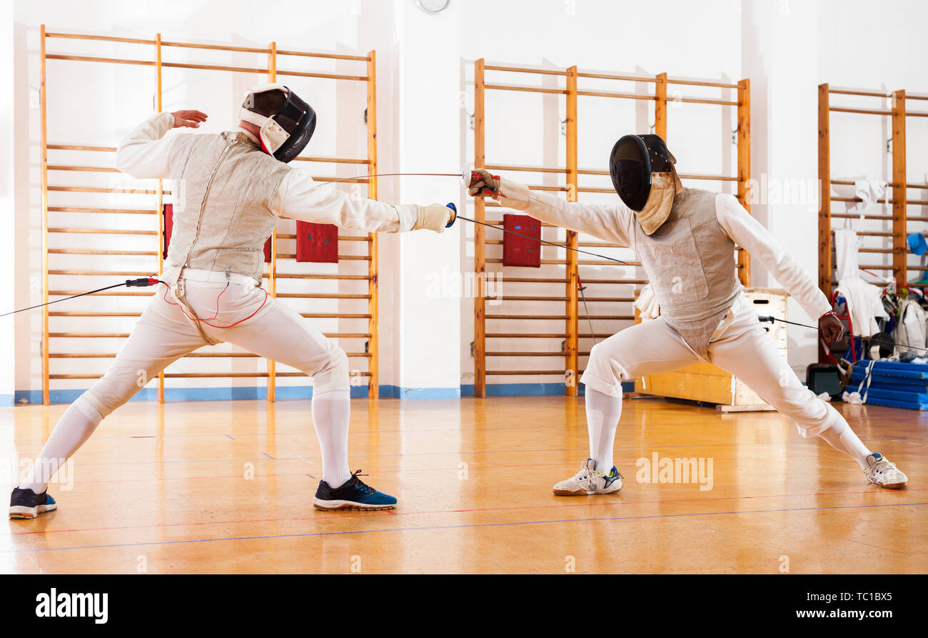 fencers at fencing workout, practicing attack movements in battle Stock ...