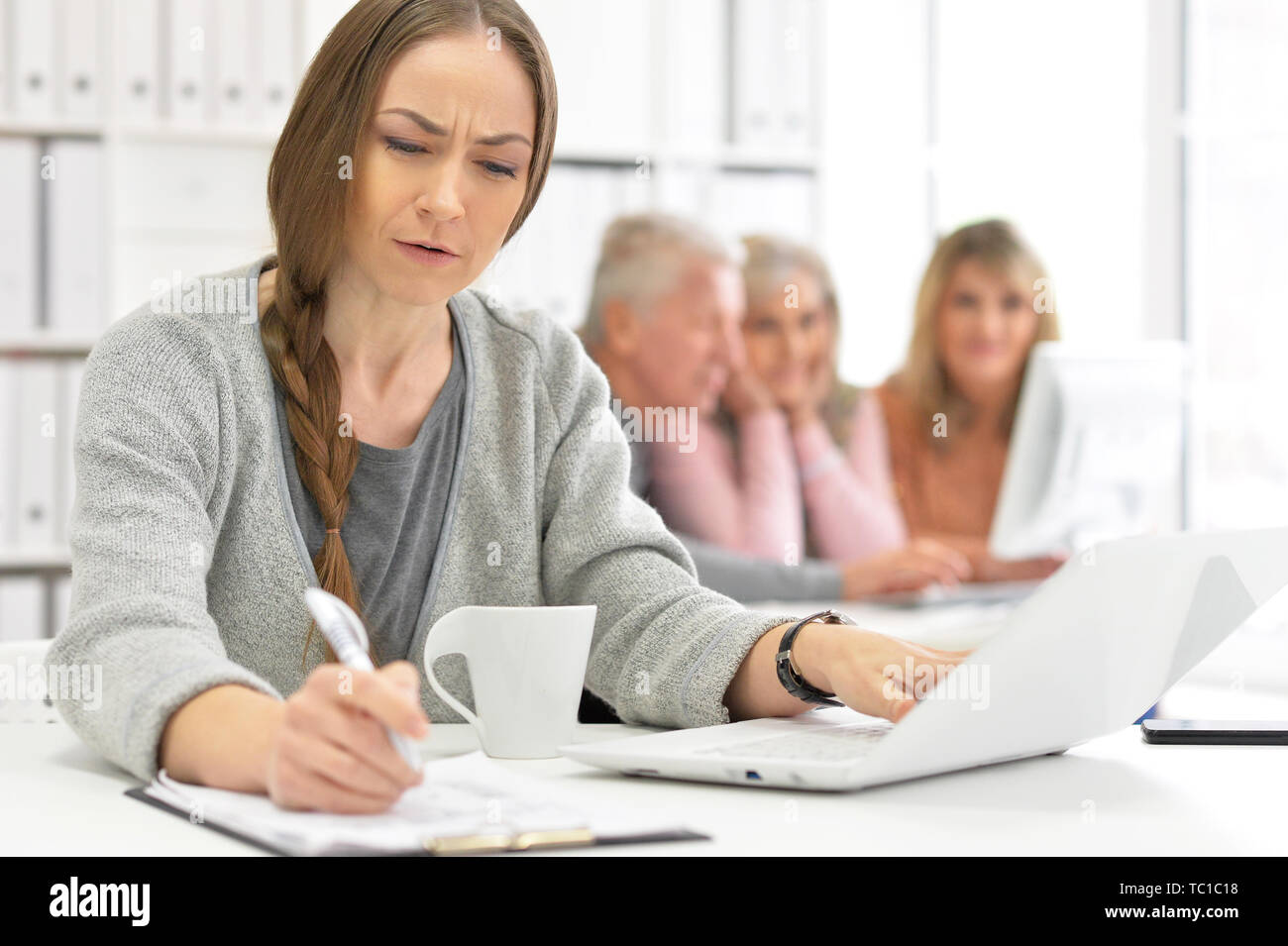 Portrait of group of active business people working Stock Photo - Alamy