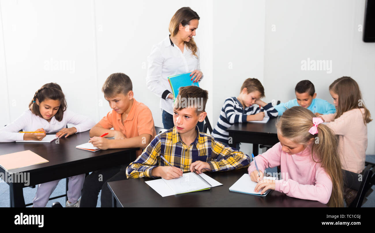 Little children learning with teacher in classroom Stock Photo - Alamy